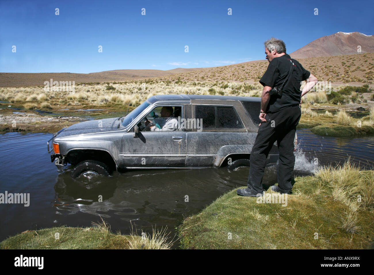 Man watching car driving through water hi-res stock photography and ...