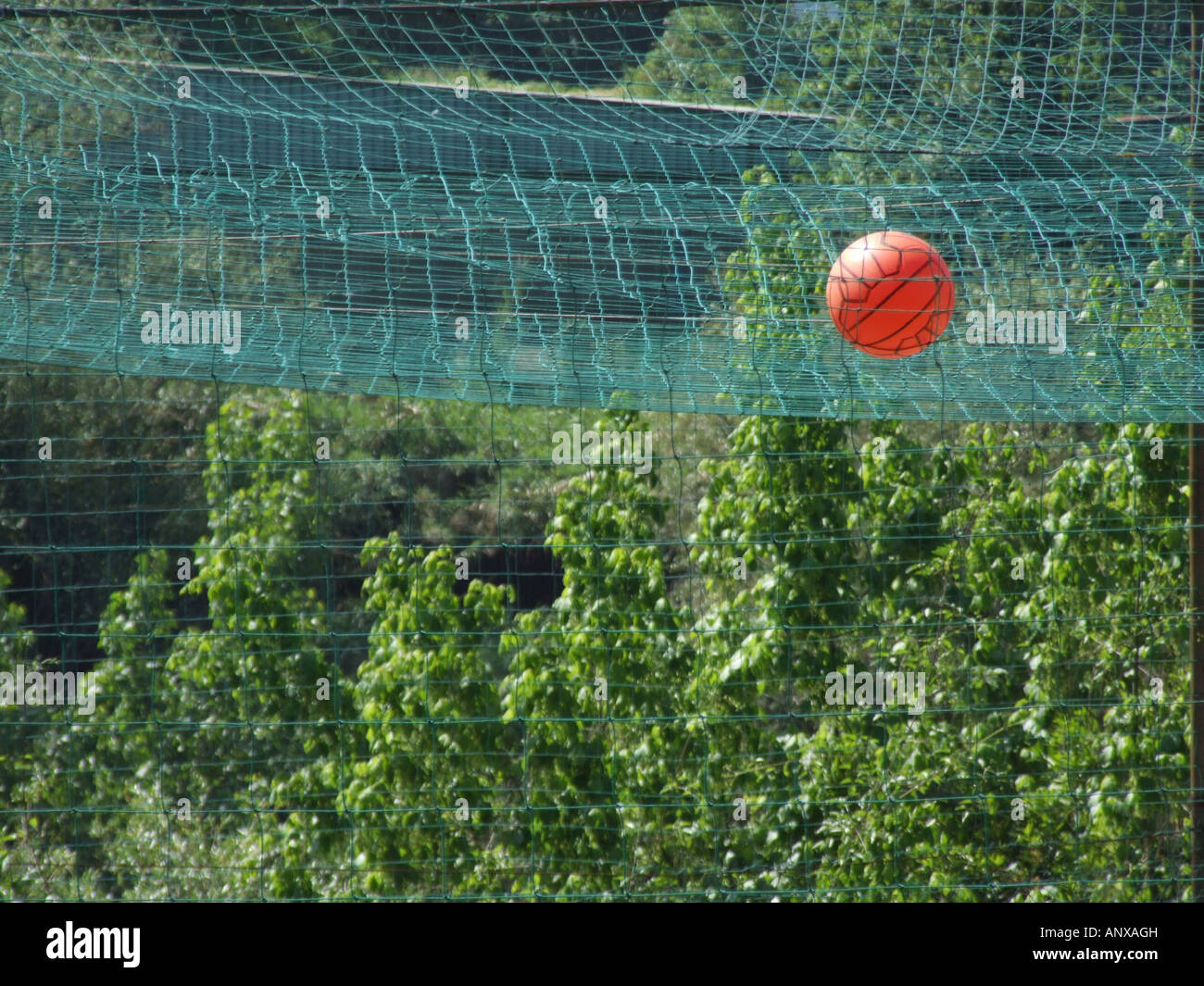 ball stuck on top of net roof in play ground Stock Photo - Alamy