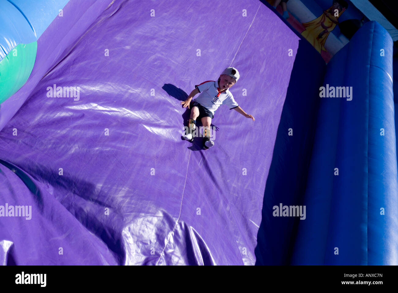 Inflatable slide boy sliding down fun hi-res stock photography and ...
