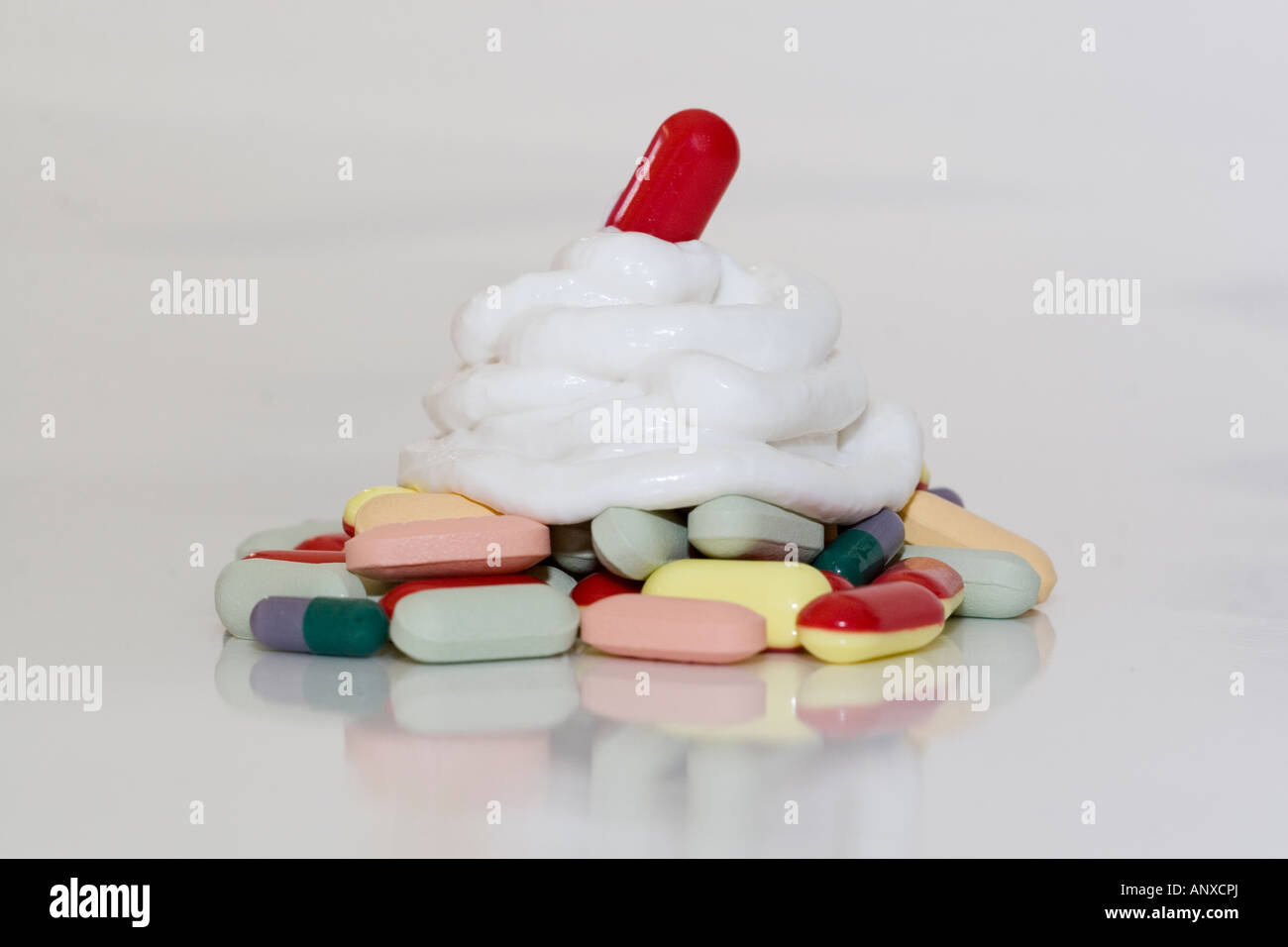 Assorted pills medication and ointments arranged to look like a dessert ...