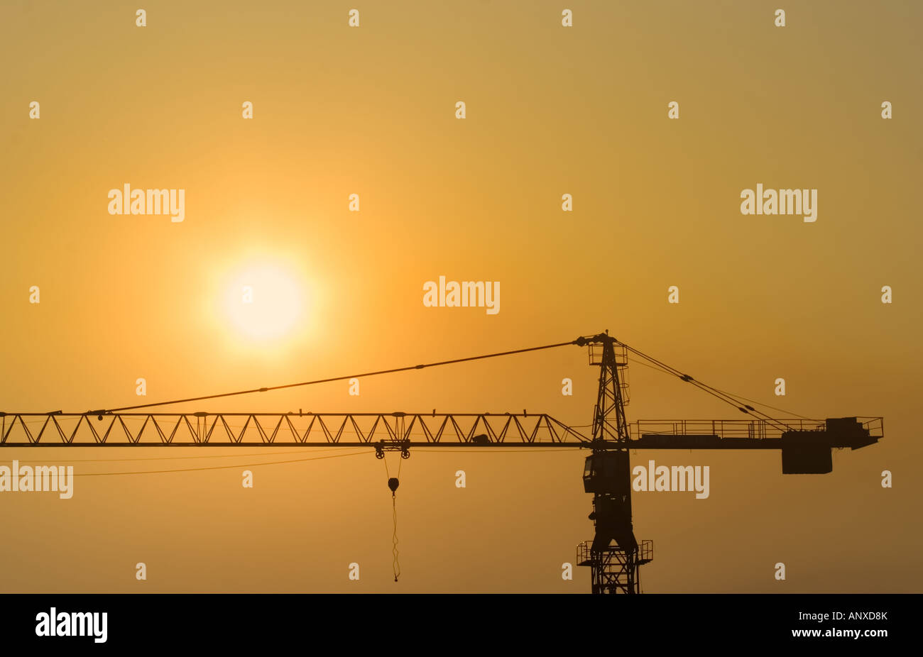 Construction crane at sunset Stock Photo - Alamy