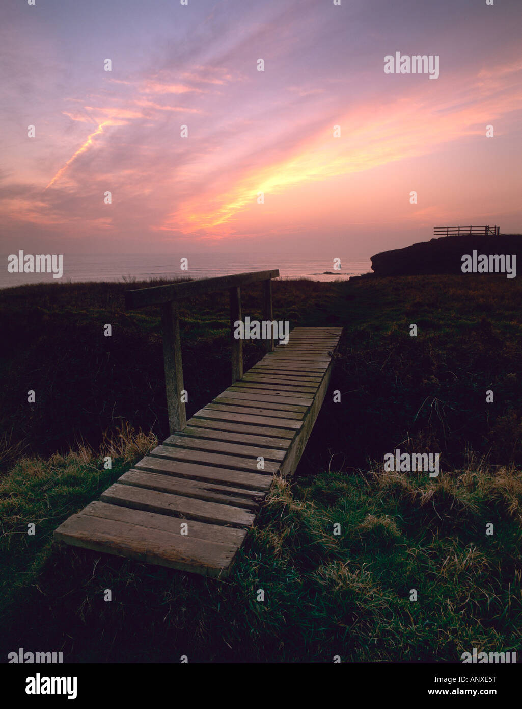 an old rickety wooden foot bridge at sunset at compton bay on the isle ...