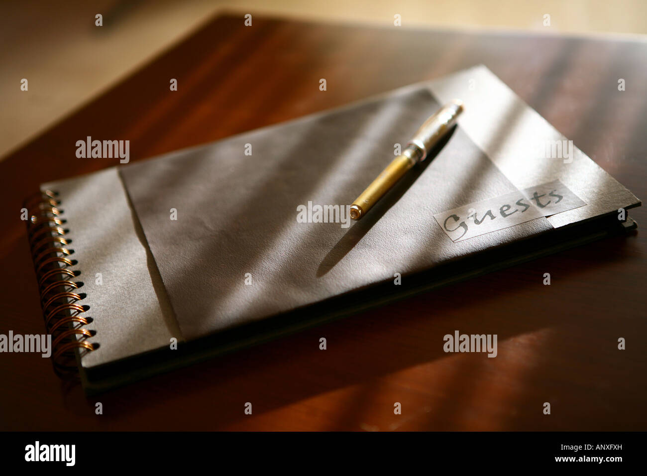 Guest/visitors comment book and pen with shadows falling across Stock ...