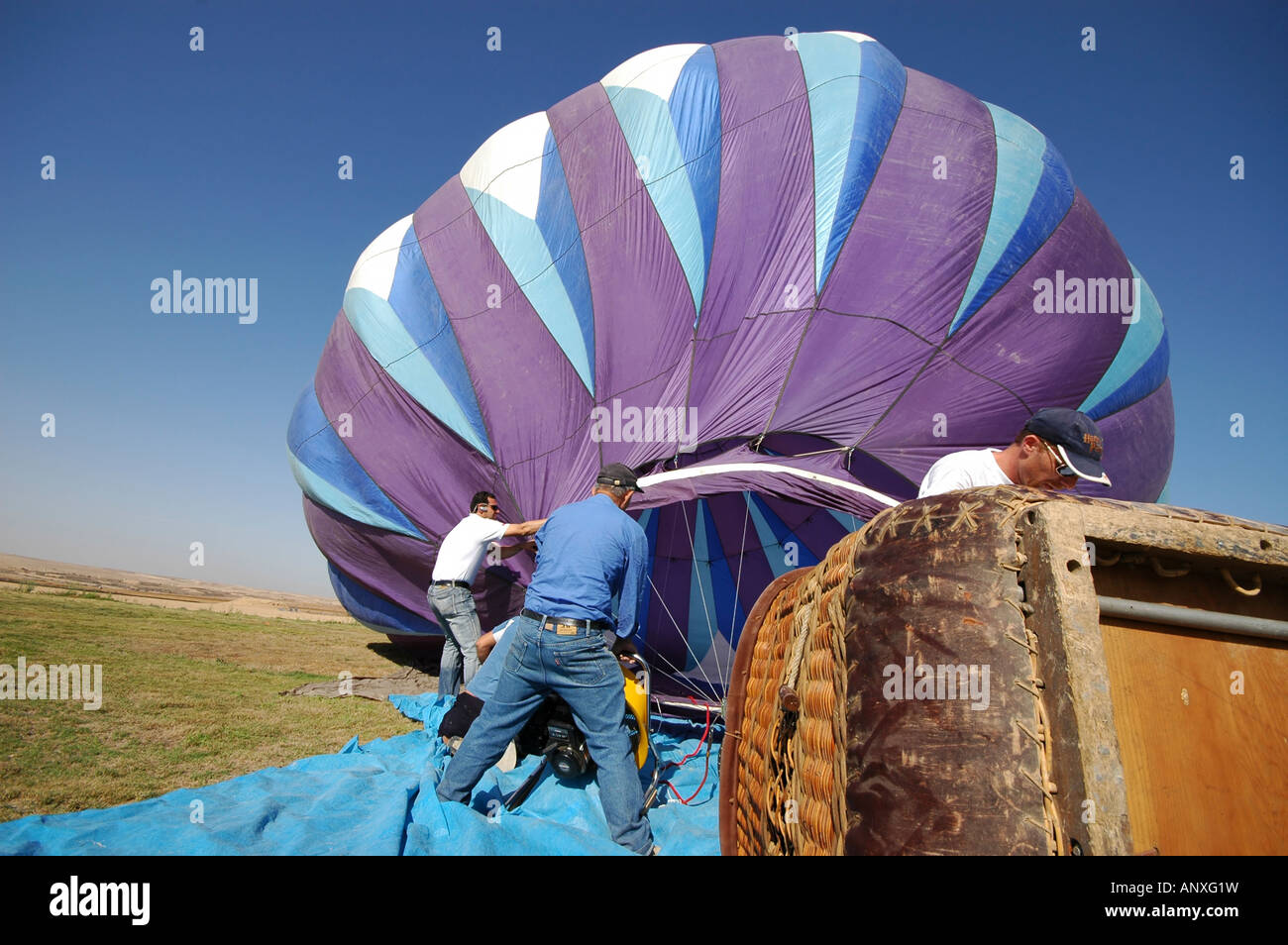 Ground crew preparing a hot air balloon before takeoff Stock Photo - Alamy