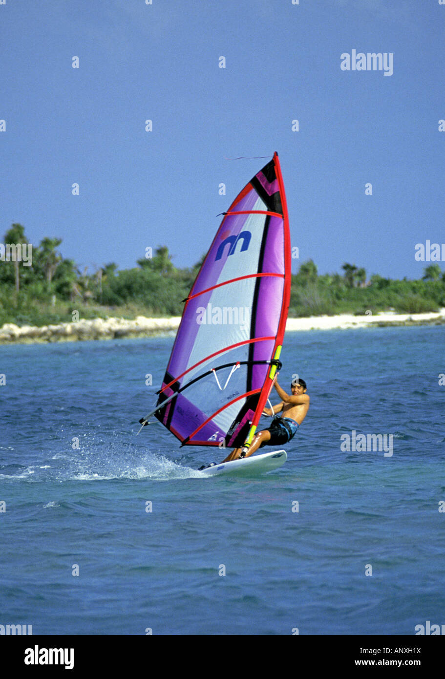 A Mexican windsurfer catches a breeze just off Cancun Island, Cancun ...
