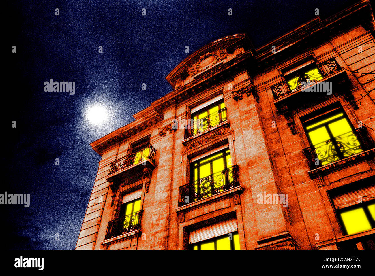old gothic style building at night with windows illuminated by lights ...
