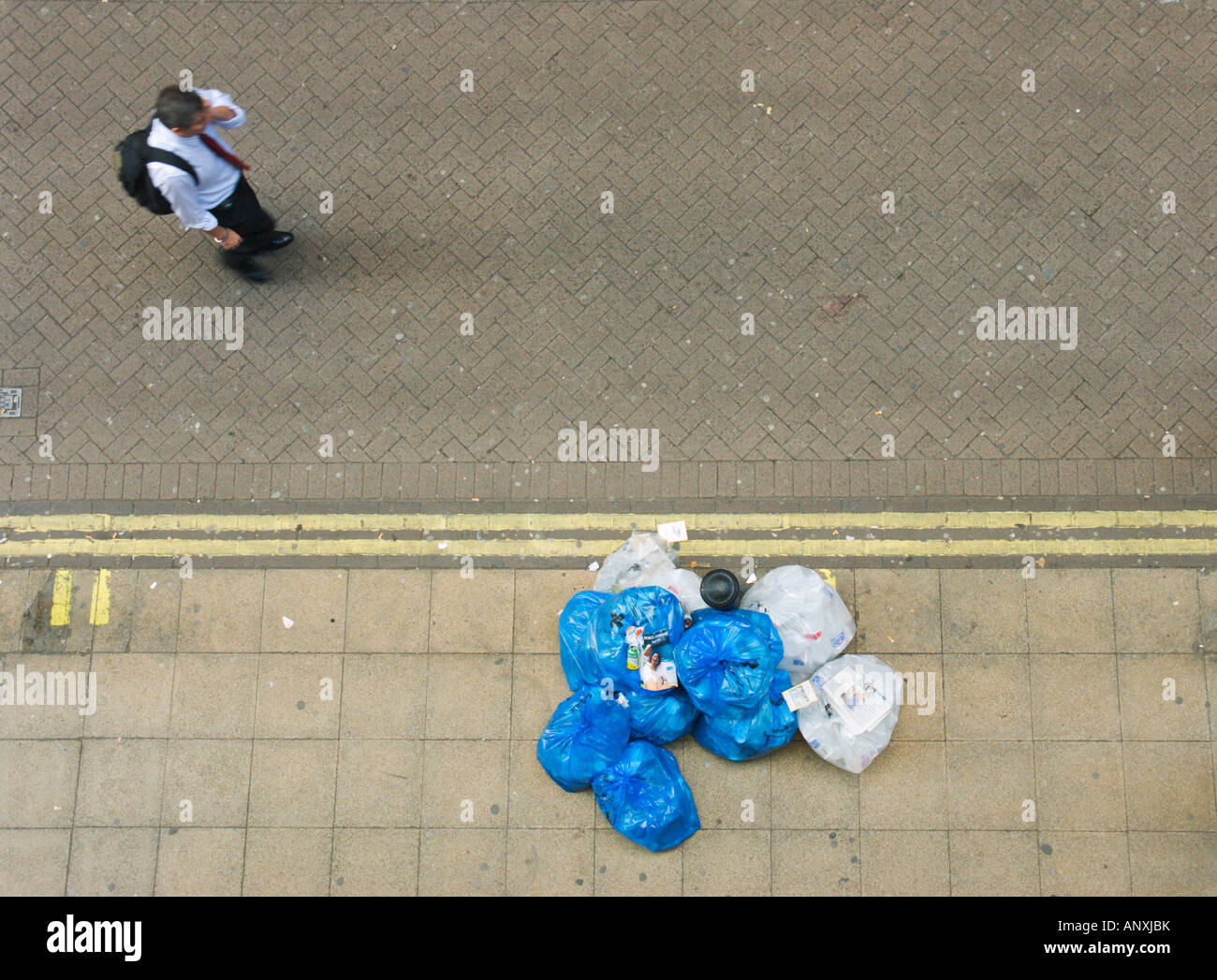 A pile of rubbish sacks and a passer-by Stock Photo - Alamy
