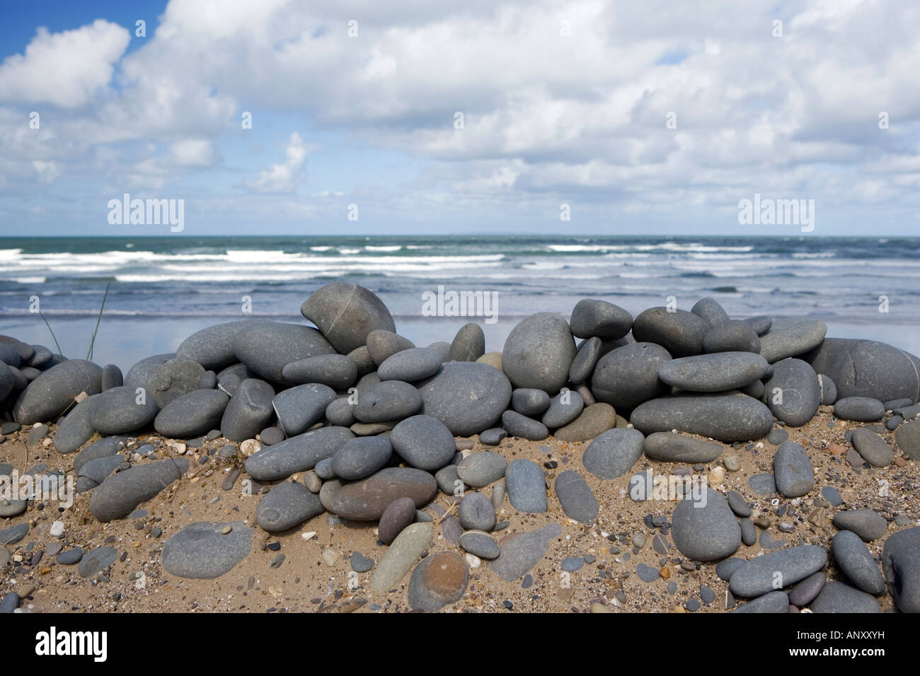 Pebbles on a sandy beach Stock Photo - Alamy