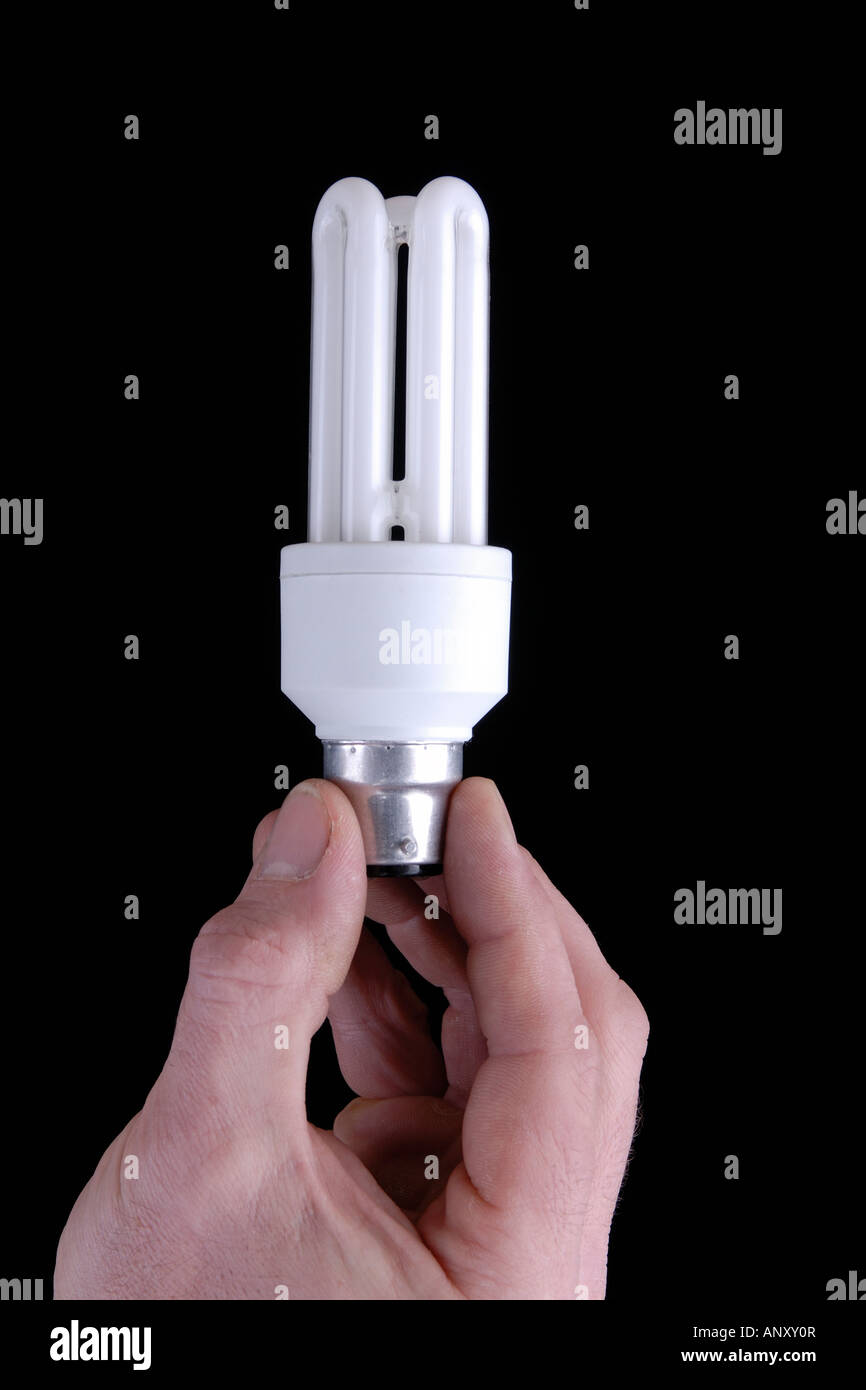 fingers holding a low energy light bulb Stock Photo - Alamy
