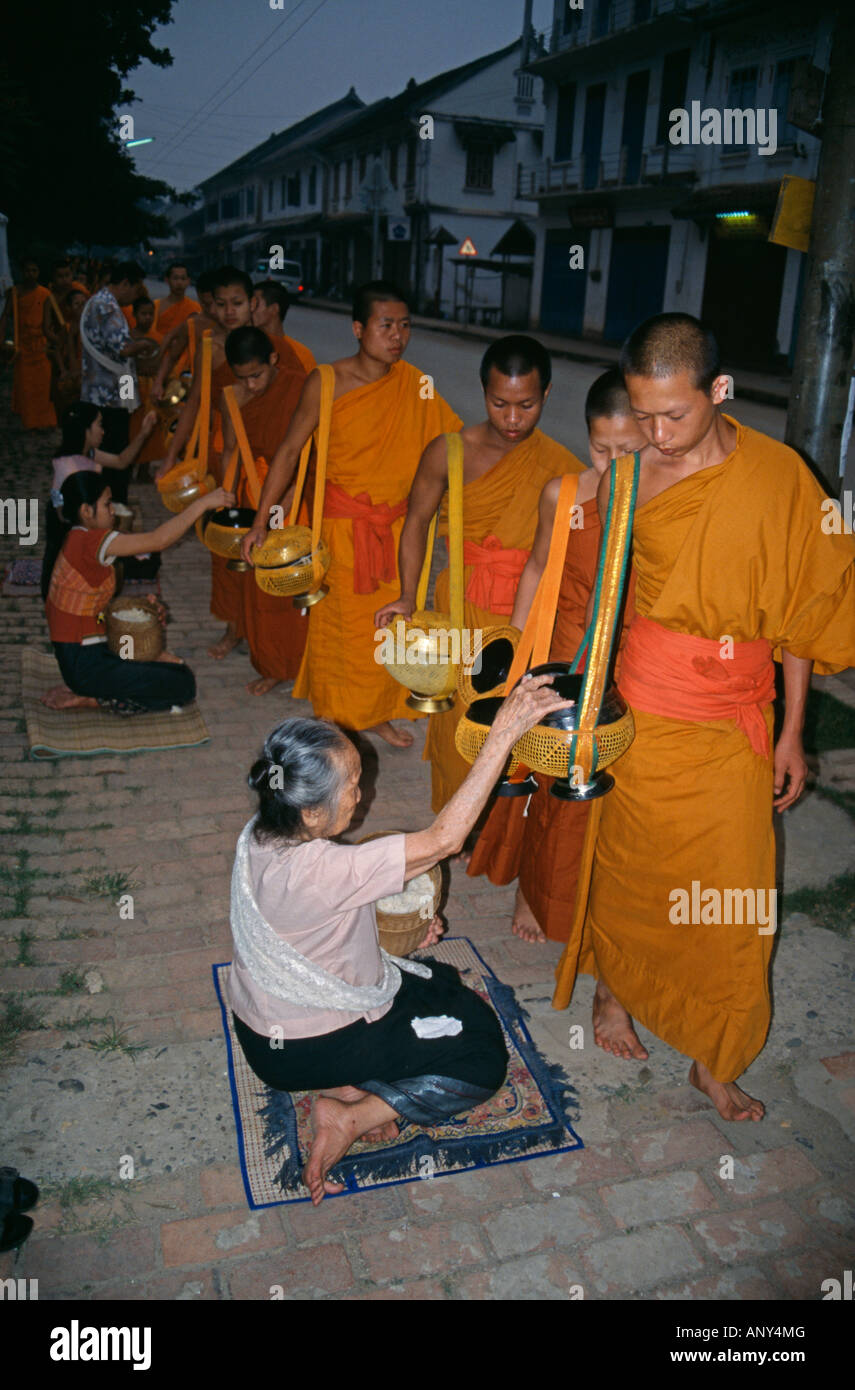 Laos, Luang Prabang Province, Luang Prabang. Monks collecting alms at ...