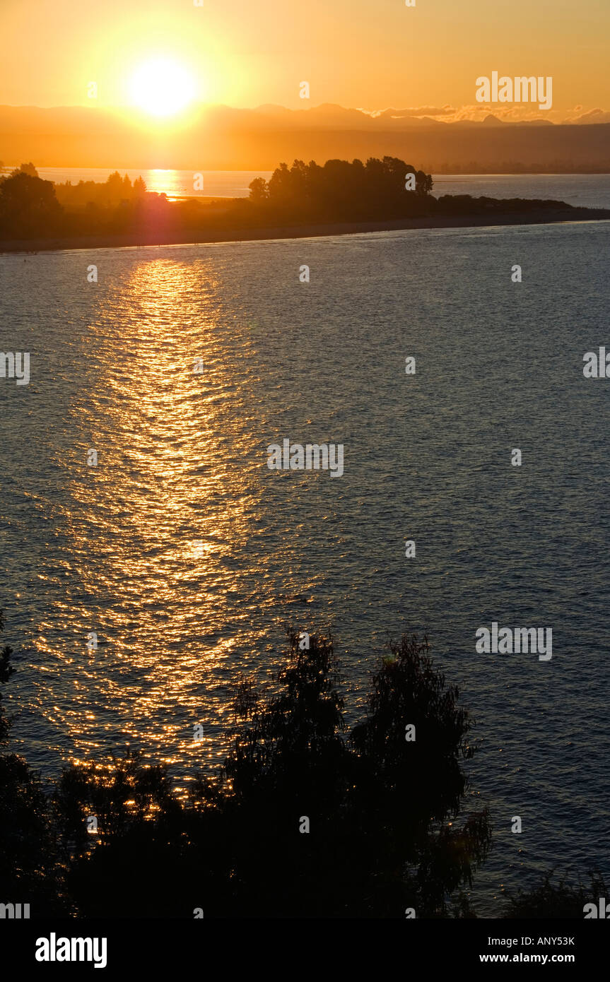 New Zealand, South Island, Nelson. Sun setting over Tasman Bay, Nelson ...