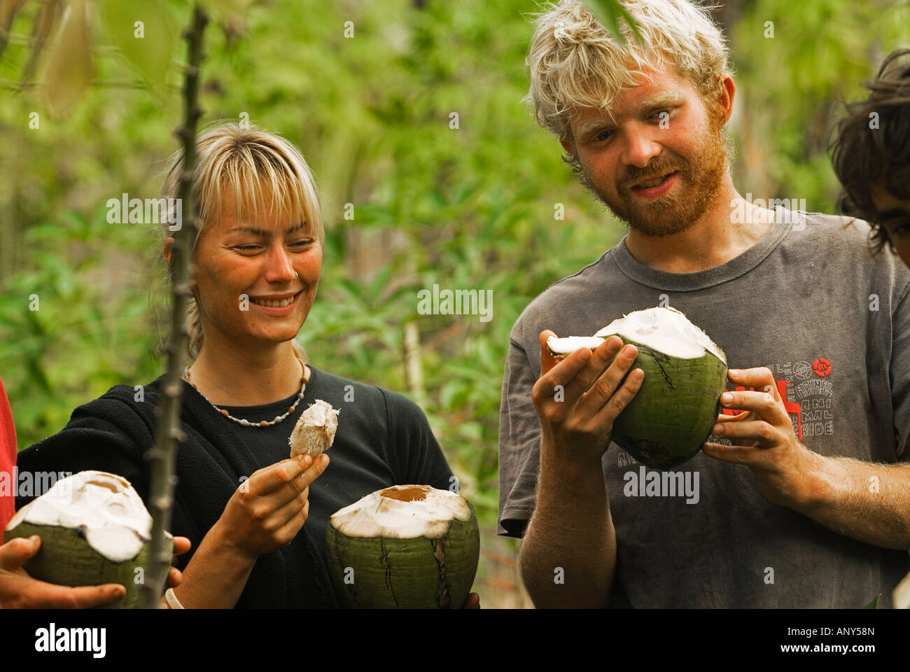 South Pacific, Fiji, Kadavu. Conservation volunteers eating fresh ...