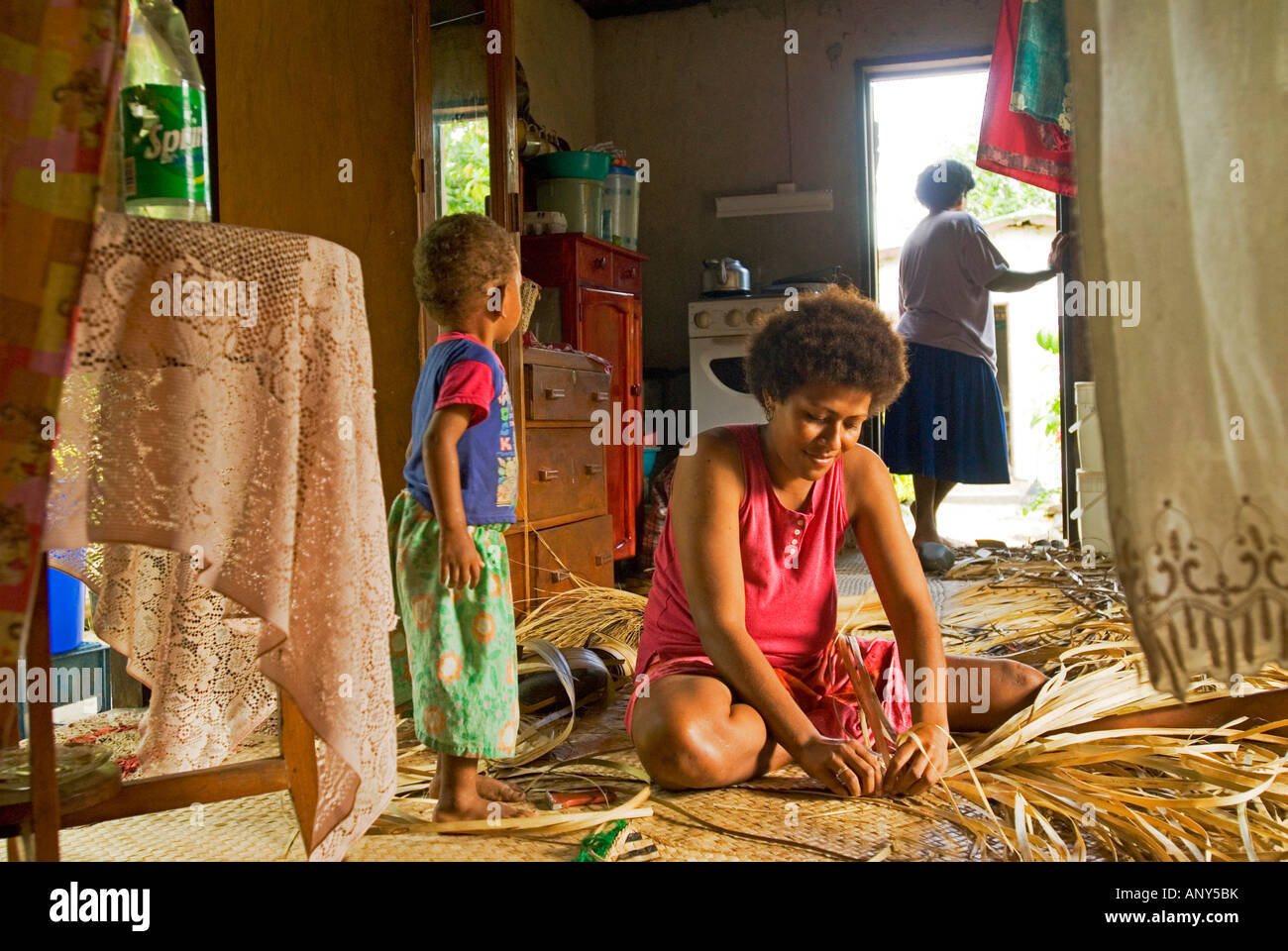 South Pacific, Fiji, Kadavu. Fijian islander creating a floor mat out ...