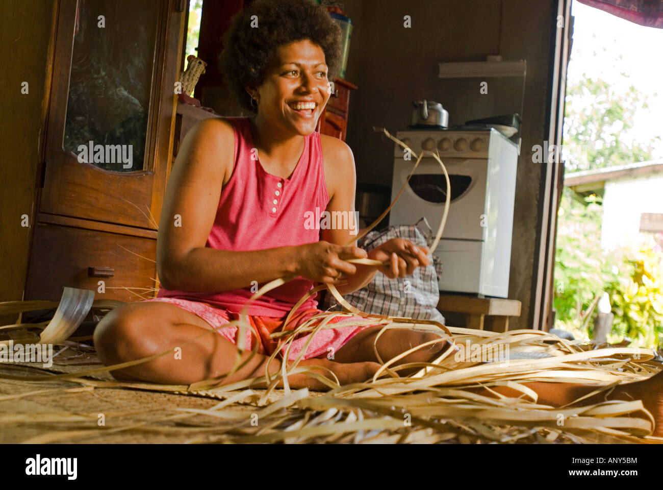 South Pacific, Fiji, Kadavu. Fijian islander creating a floor mat out ...