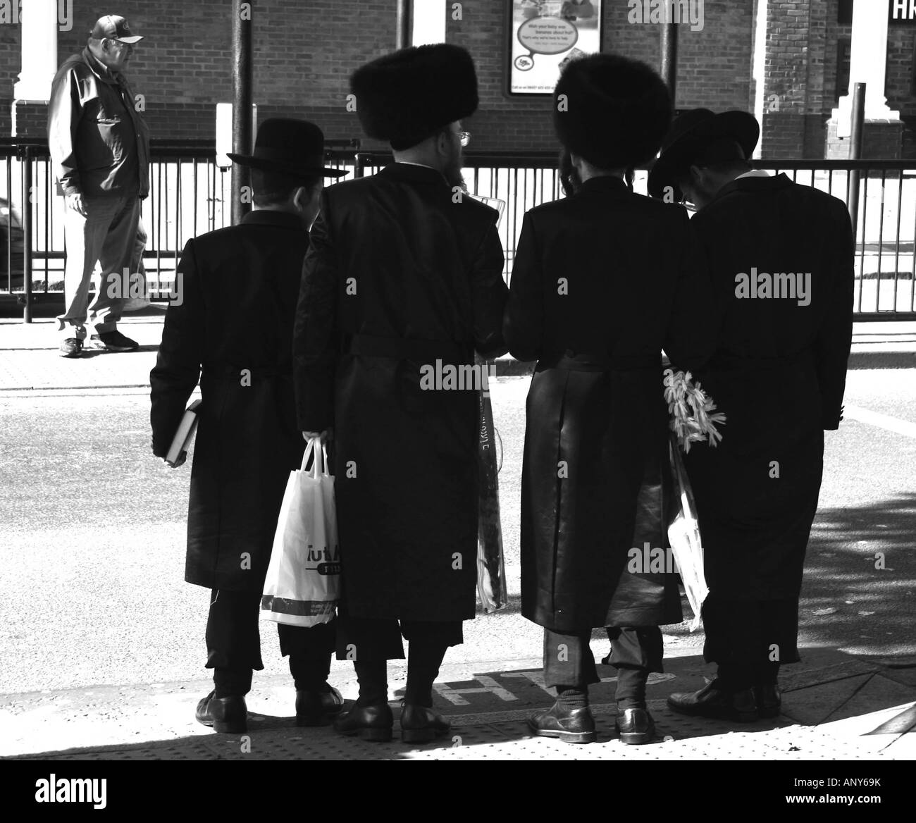 Back view of 4 Authodox Jews, Hasides a t thge curb, wierd dress, fur ...
