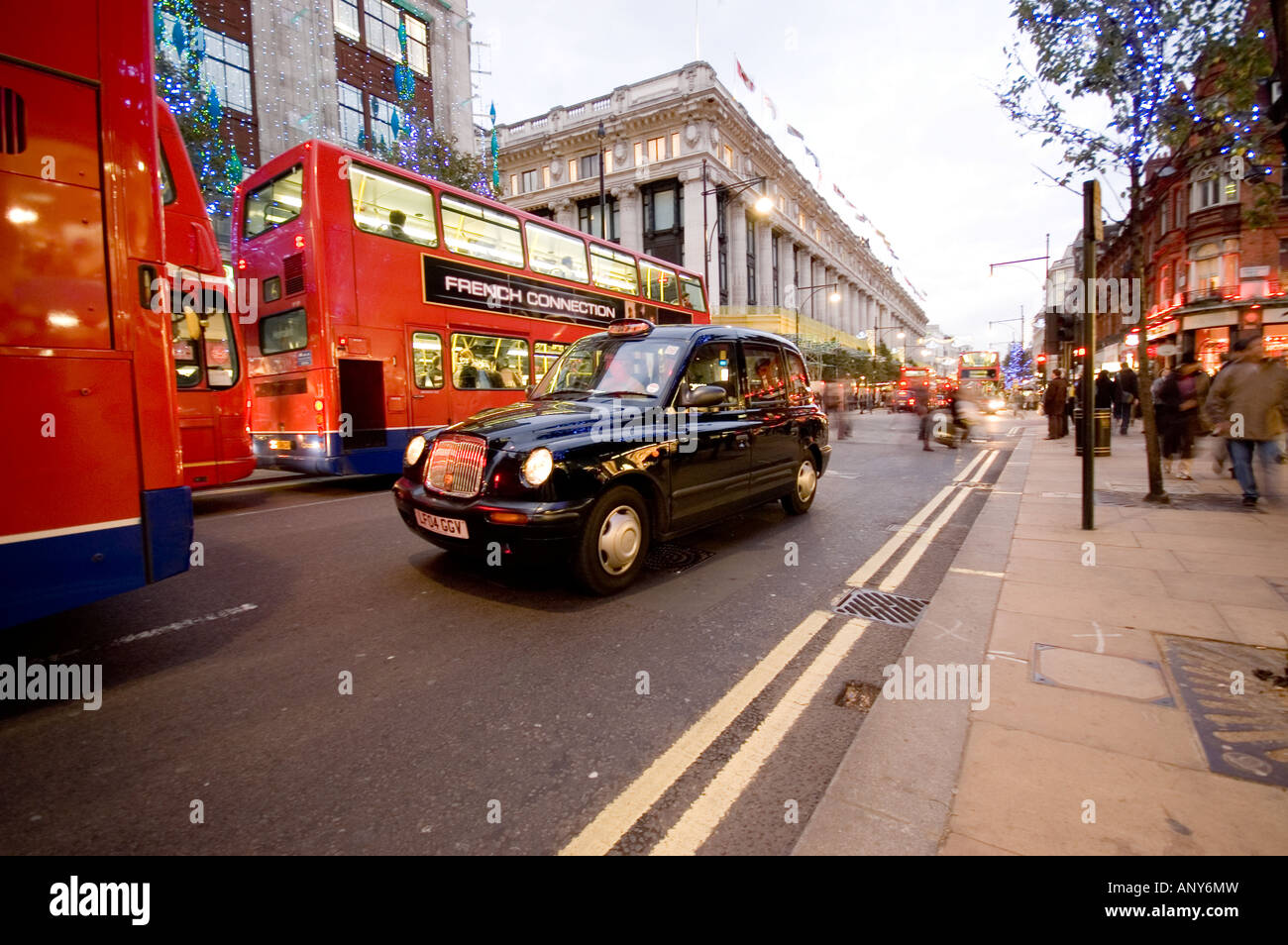red double decker and black taxi queue in oxford street at evening ...