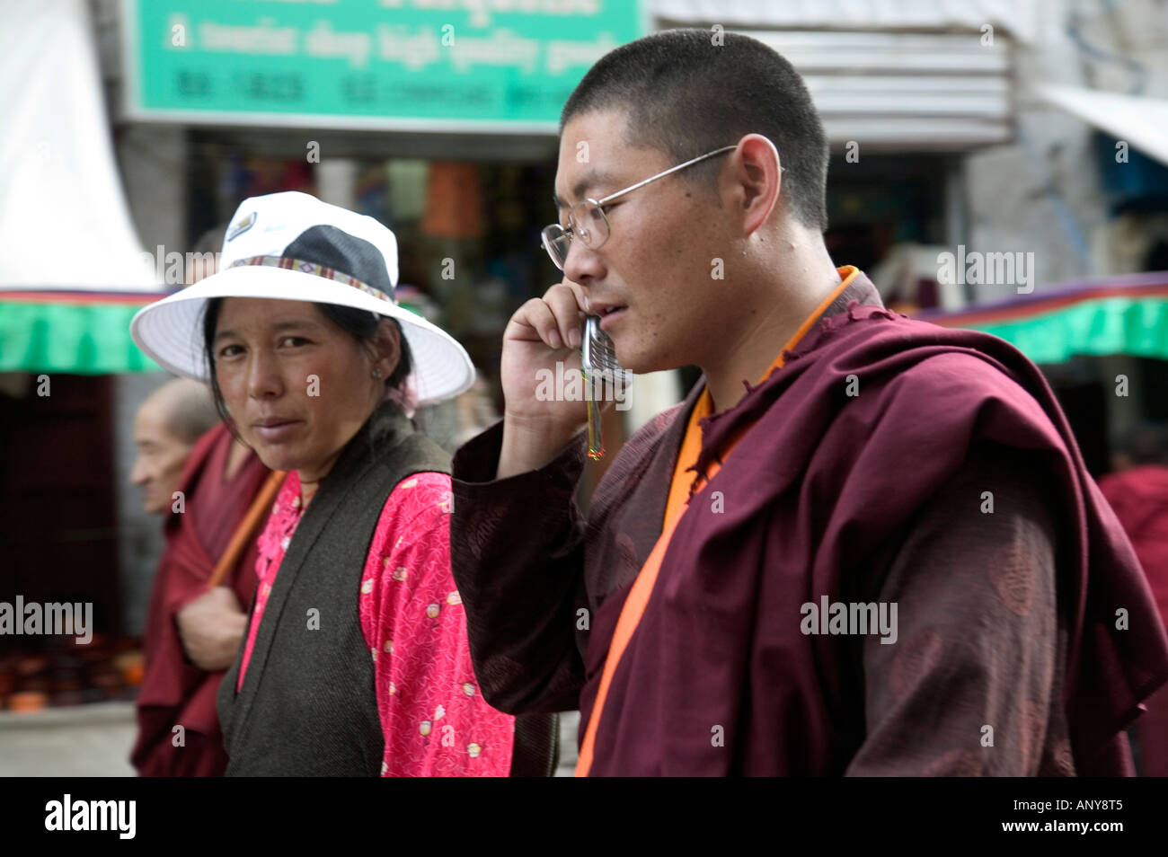 Buddhist monk using a mobile phone Barkhor Square Lhasa Tibet China ...