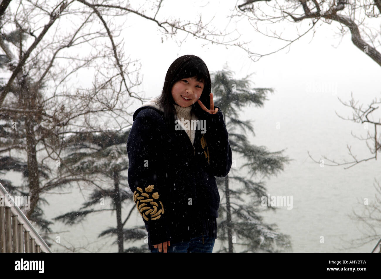 A Chinese beauty stands in the snow during a very big winter storm that ...