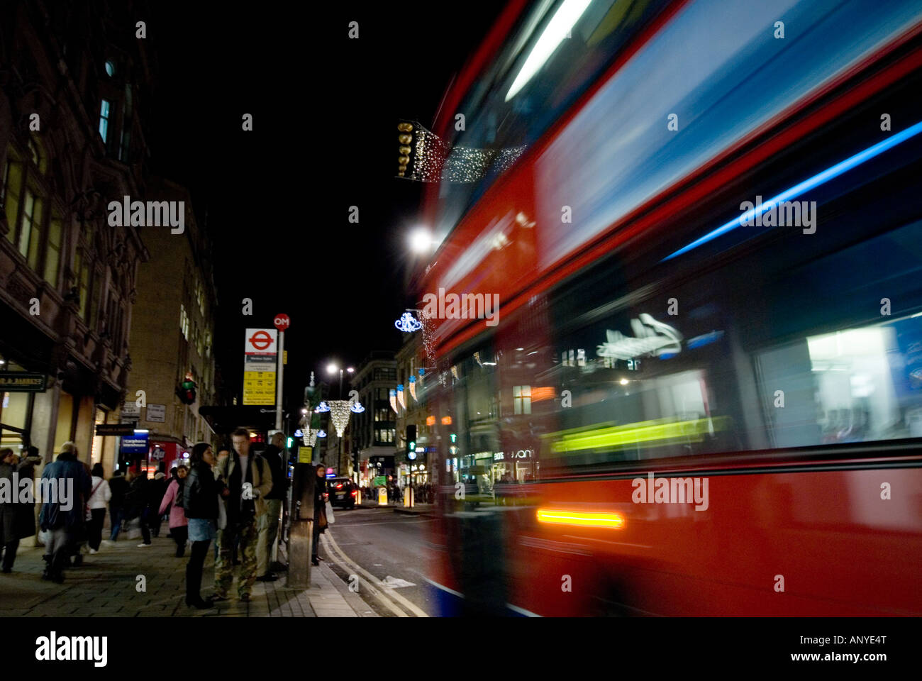 people waiting for the red bus stop in oxford street at evening london ...