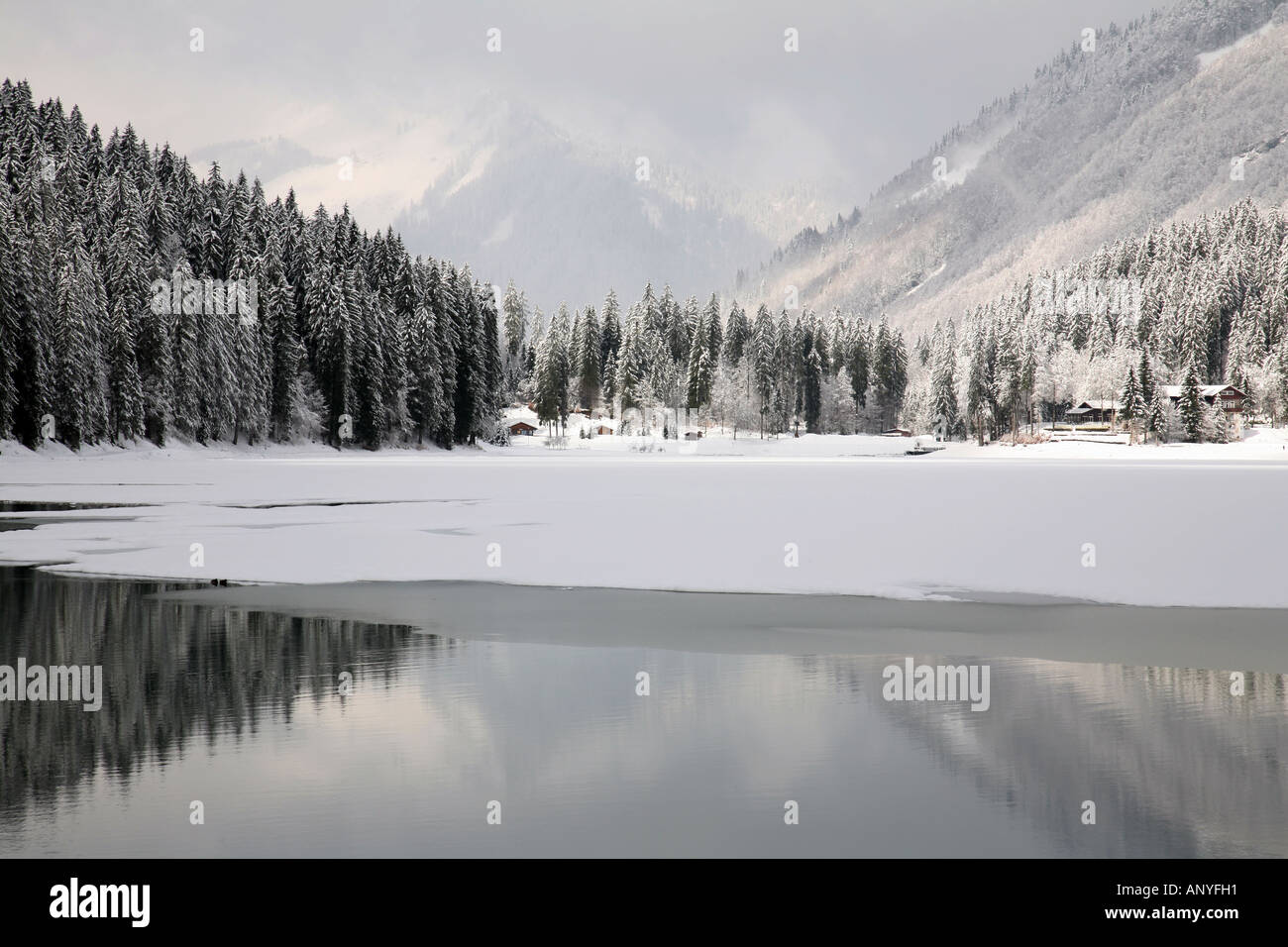 Lac de Montriond, Morzine, with reflection of snow covered mountains ...