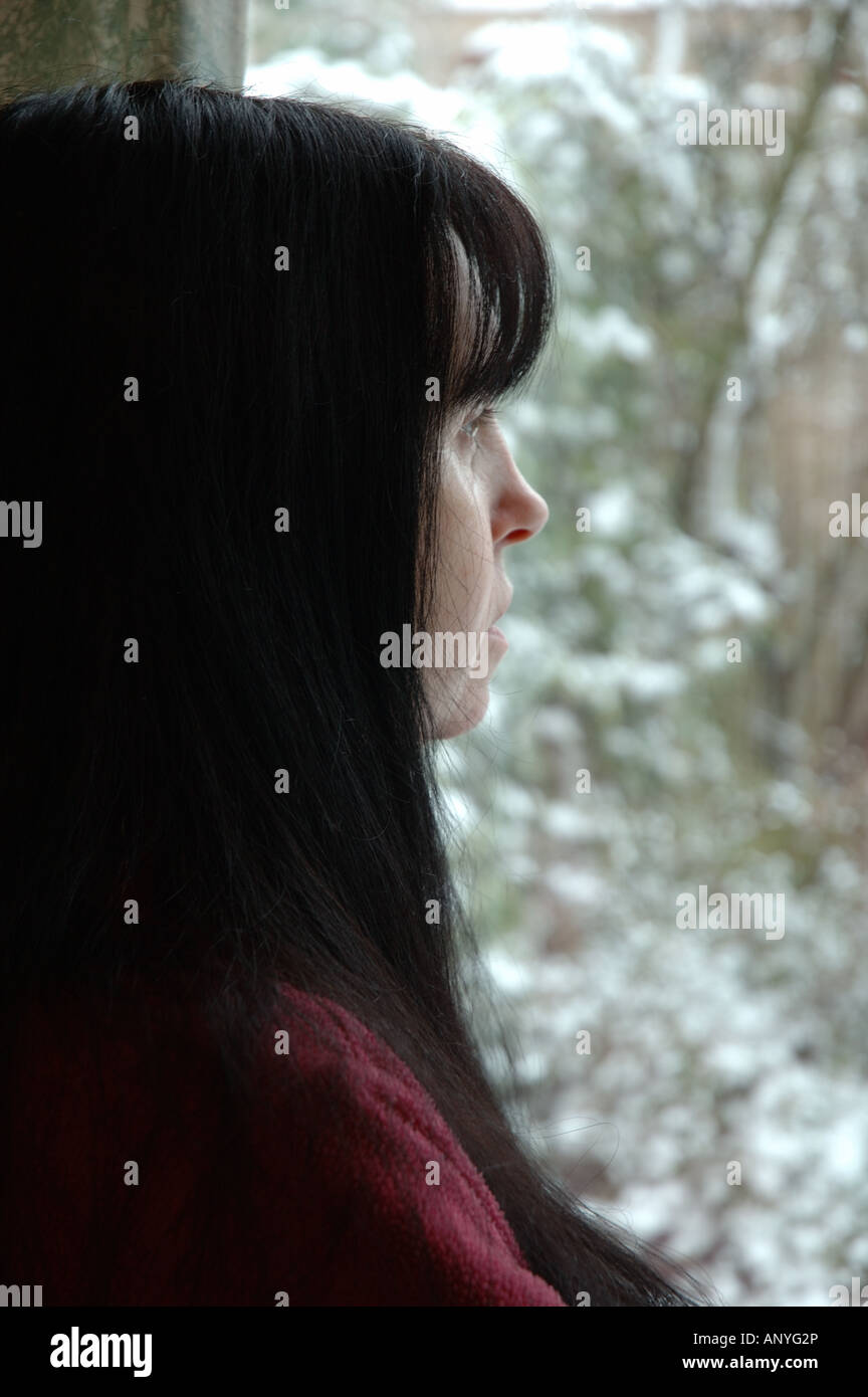Woman staring out through window hi-res stock photography and images ...
