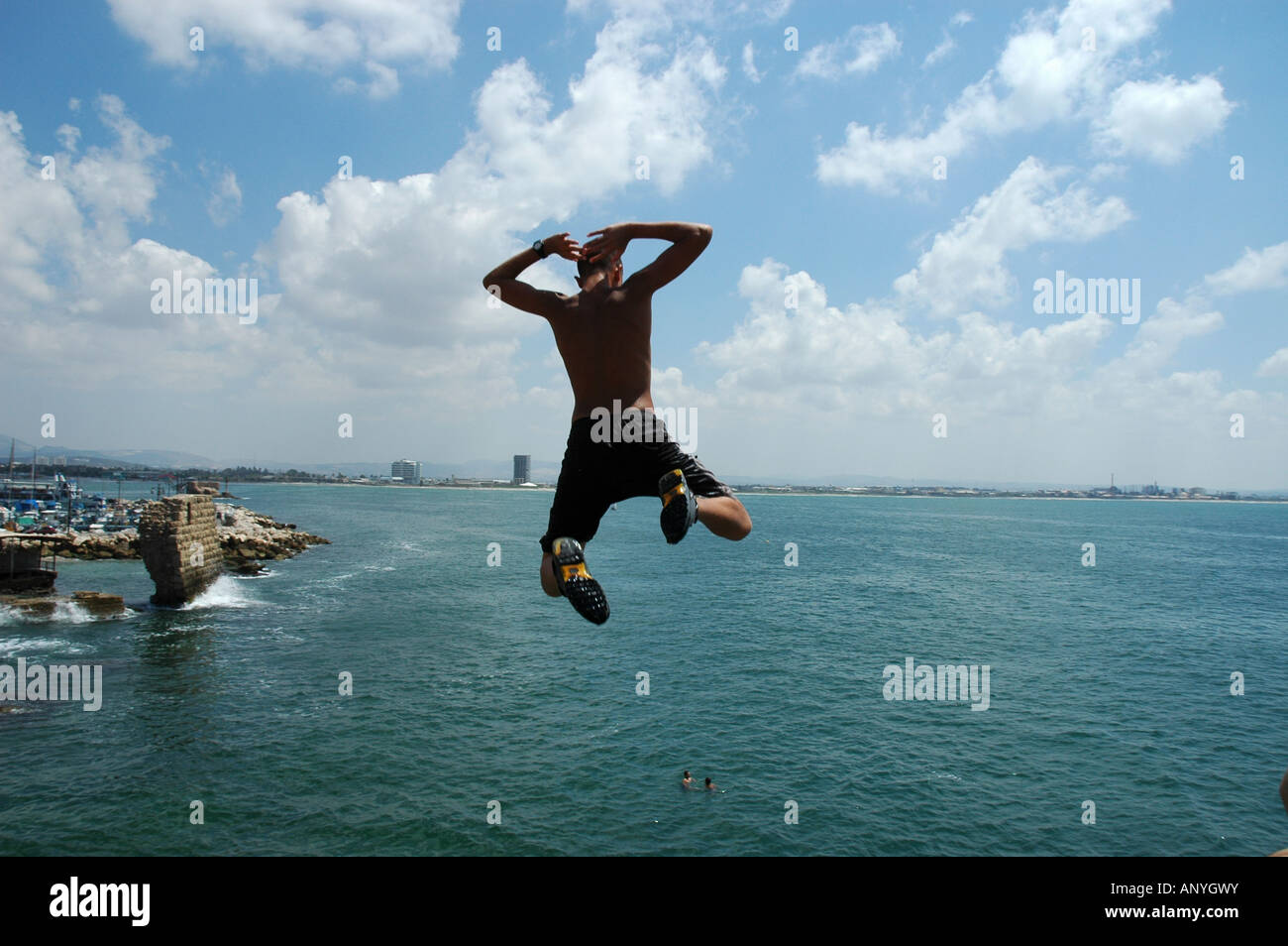 Boy jumping off wall into sea hi-res stock photography and images - Alamy