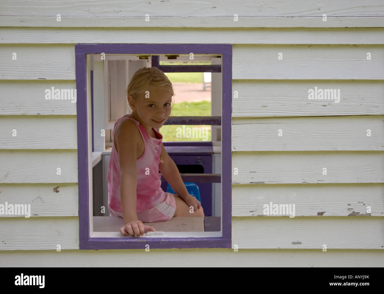 Child in the window of a playhouse Stock Photo - Alamy