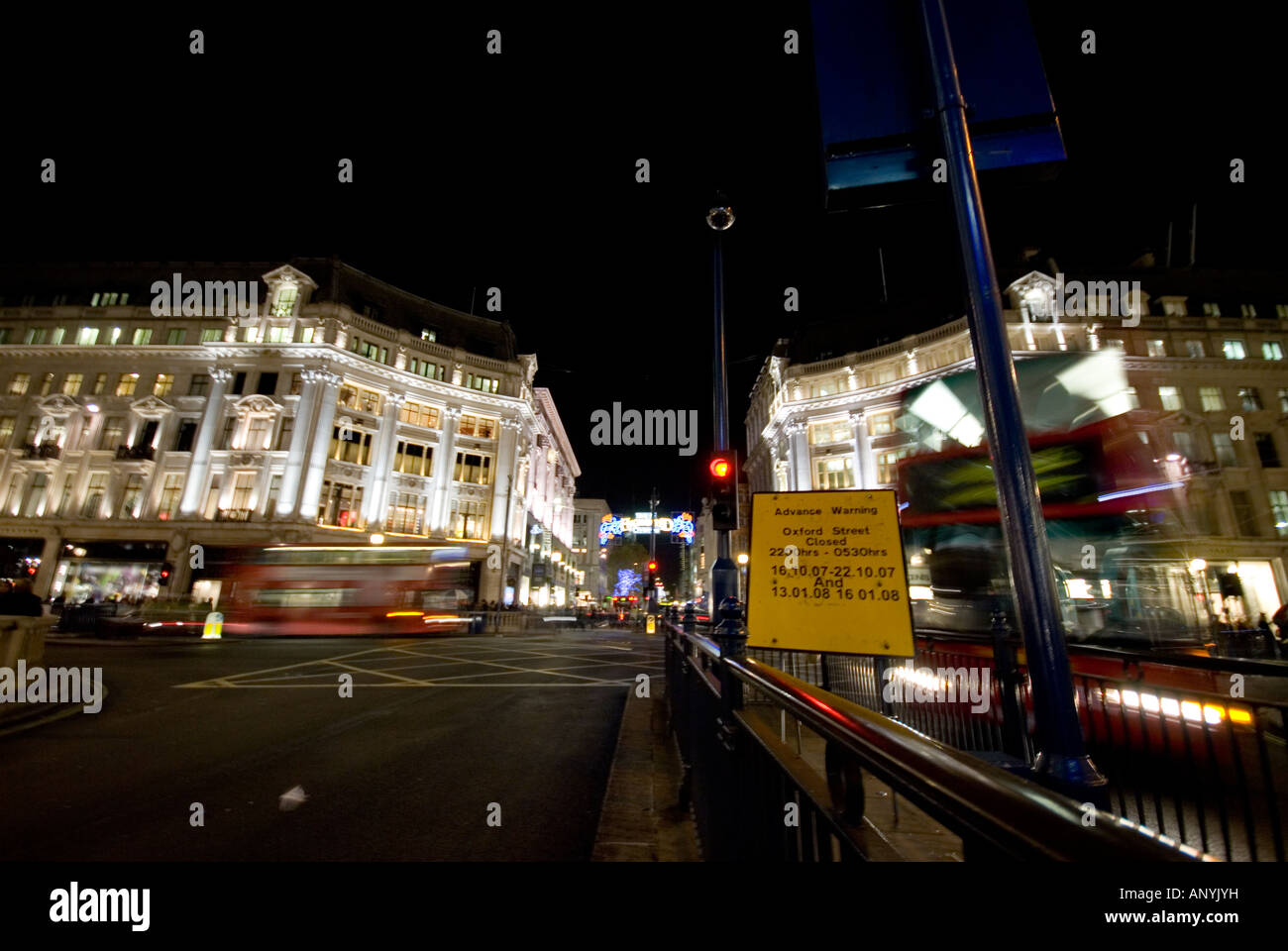 oxford street traffic sign for deviation and red bus by night london ...
