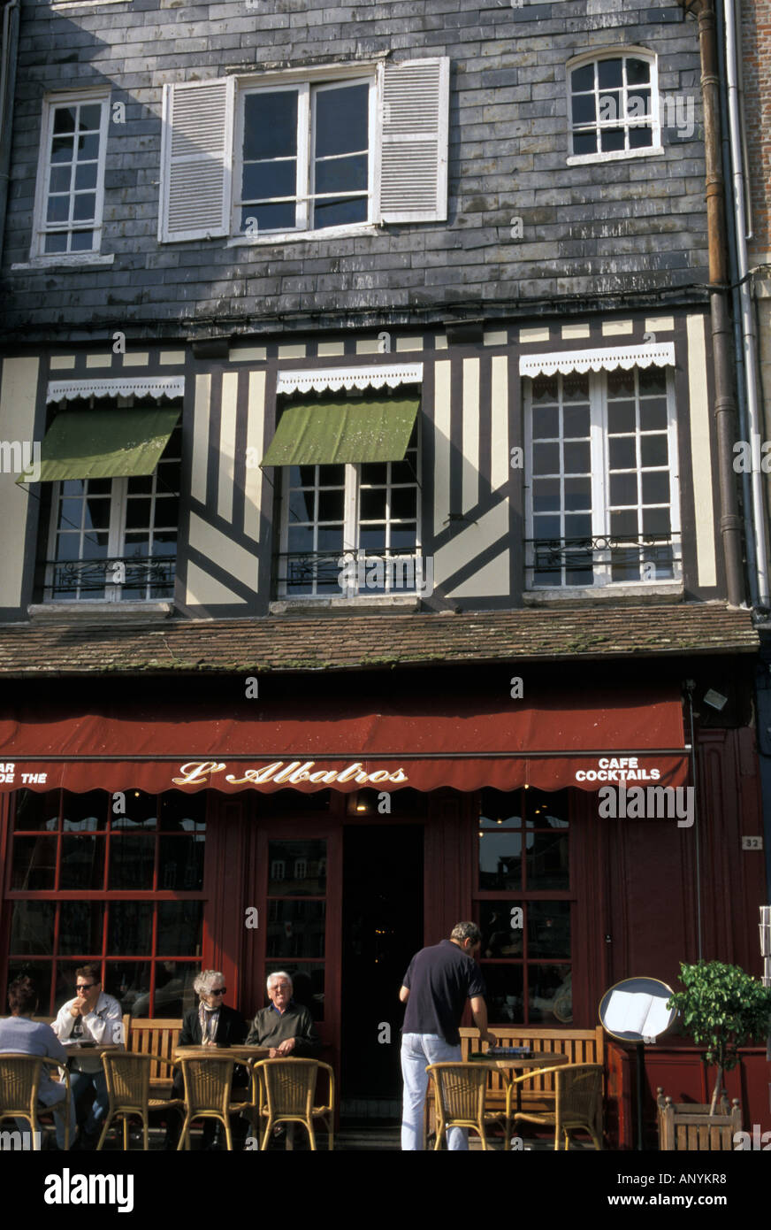 Europe, France, Normandy, Honfleur. Cafe in popular inner harbor area ...