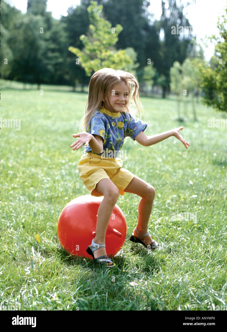girl jumping on airball in park MR8412 Stock Photo - Alamy