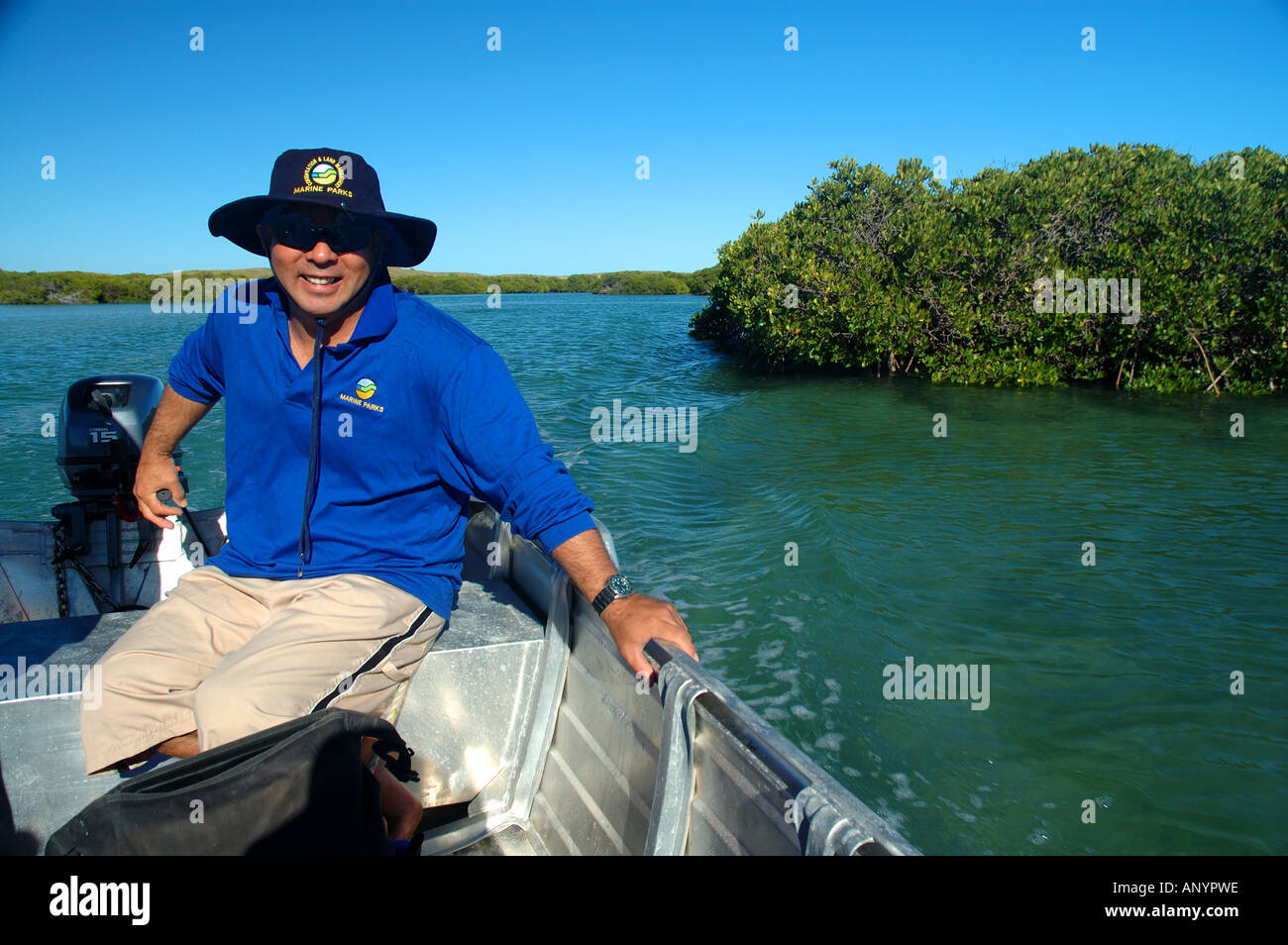 Marine research scientist Kevin Bancroft in mangrove lined creek on ...