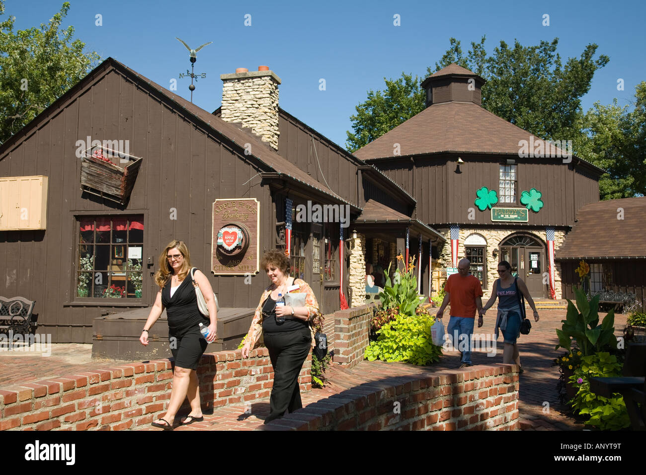 ILLINOIS Long Grove Two women walking on brick bridge retail stores in ...