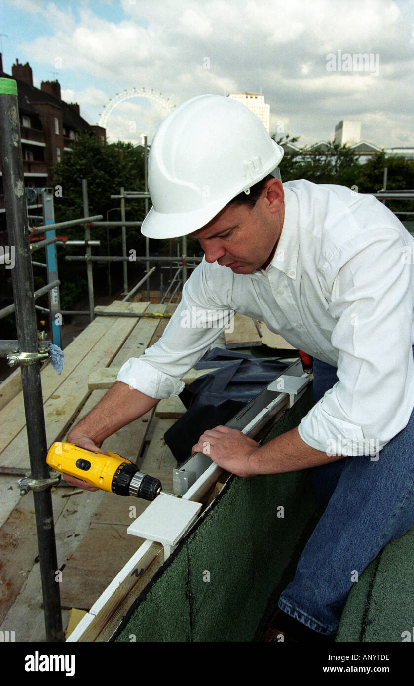 Construction worker working on a new solar powered home Lambeth London ...