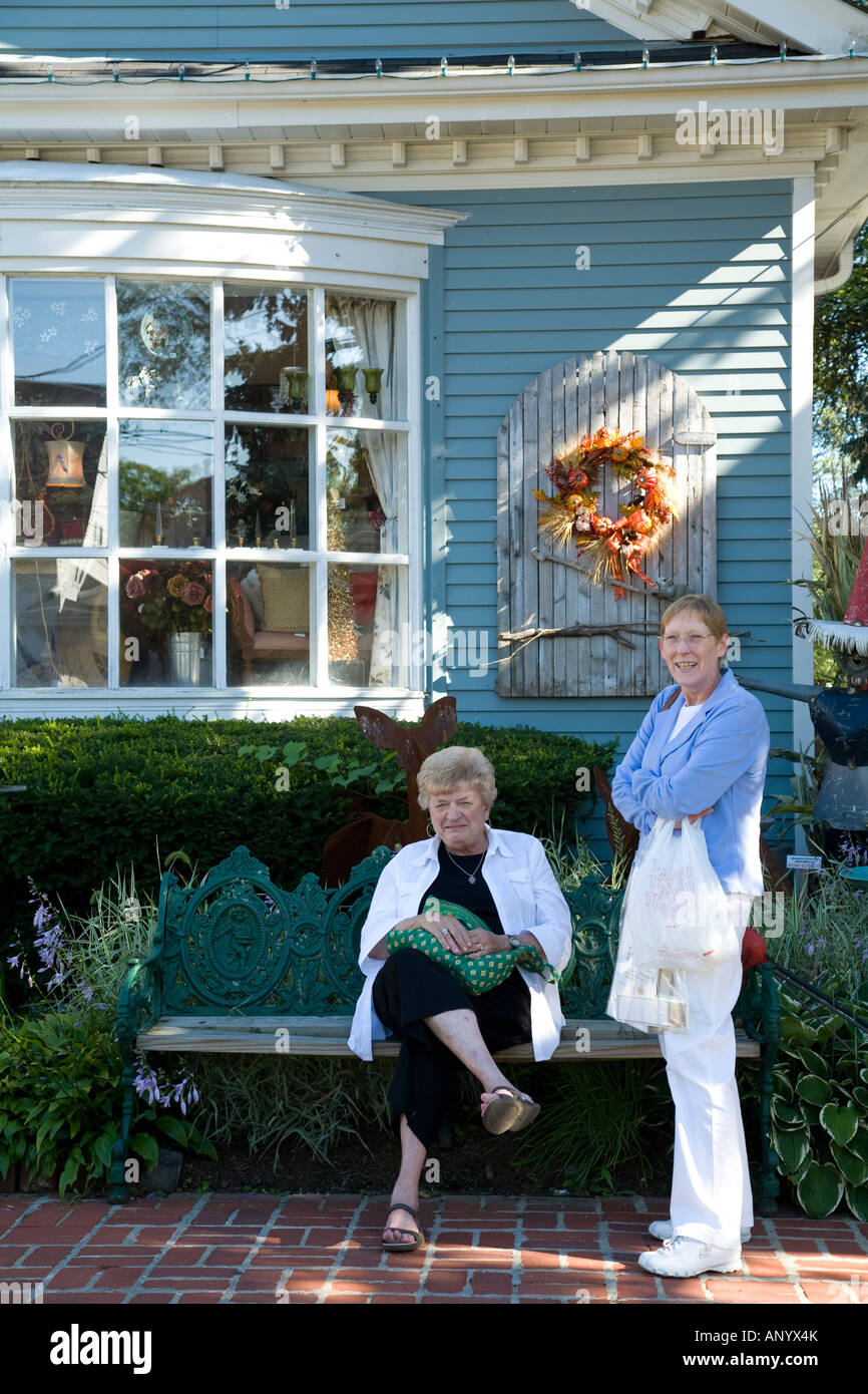 ILLINOIS Long Grove Two women shoppers rest outside retail store in ...