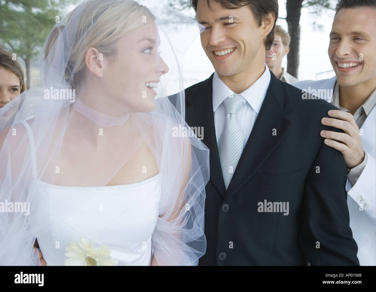 Bride and groom surrounded by friends Stock Photo - Alamy