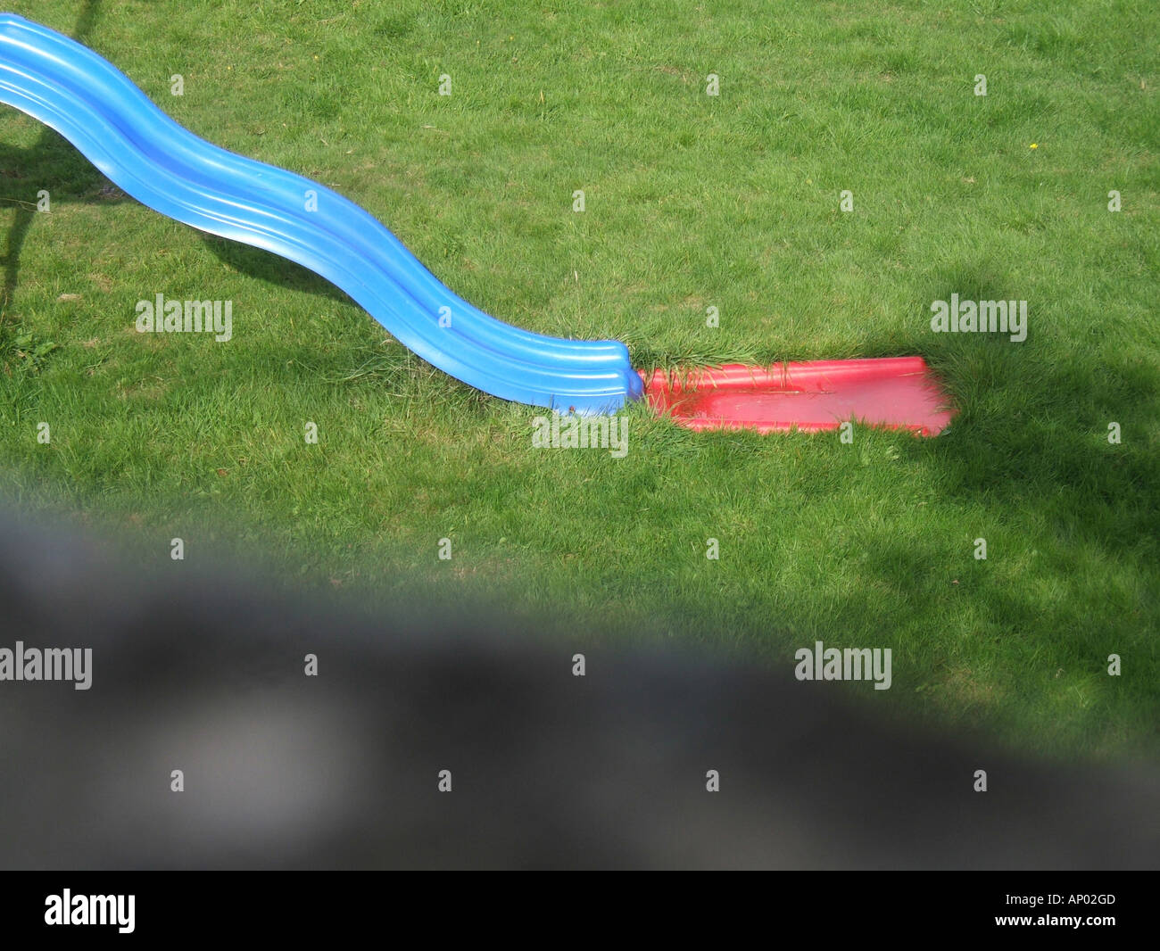detail of plastic playground slide in field garden Stock Photo - Alamy