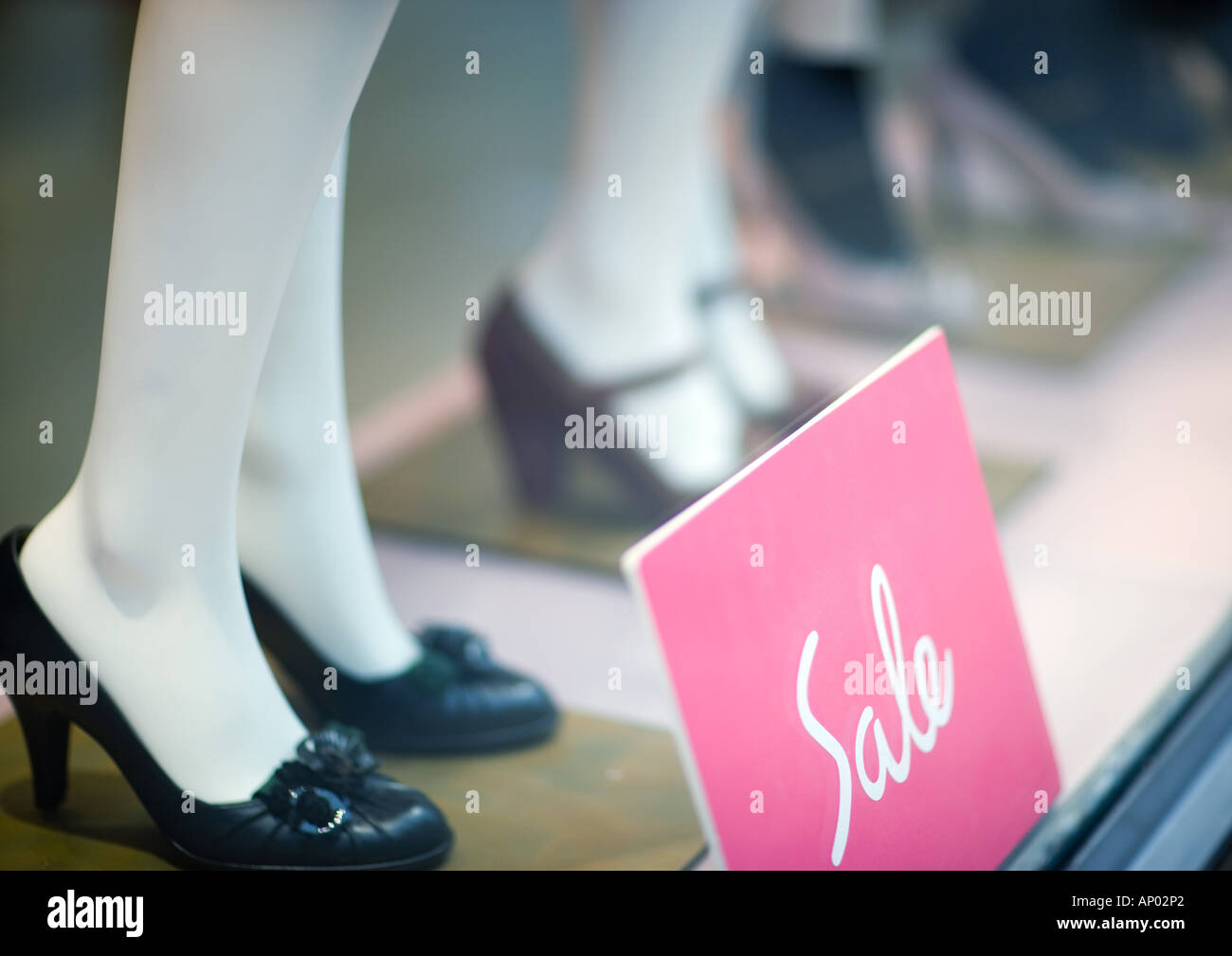 Sale sign by mannequins' feet in shop window Stock Photo - Alamy