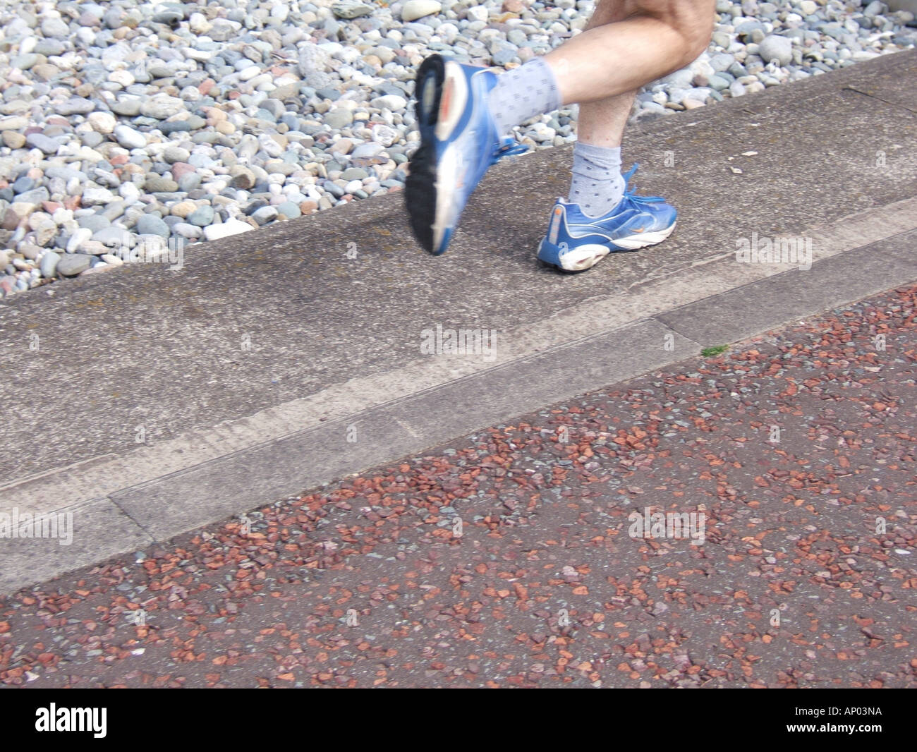 detail of man running on pavement sidewalk Stock Photo - Alamy