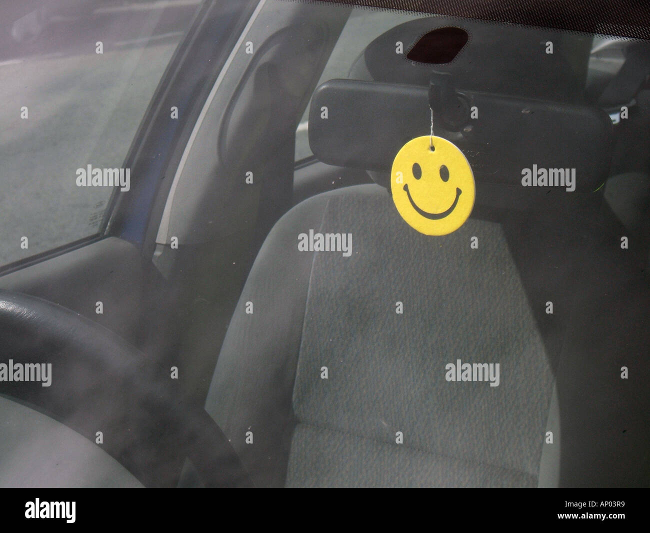 hanging smiley face sticker in car Stock Photo - Alamy