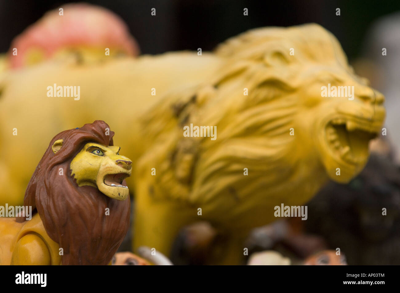 two yellow lion miniature plastic toy figures posed to pounce with ...