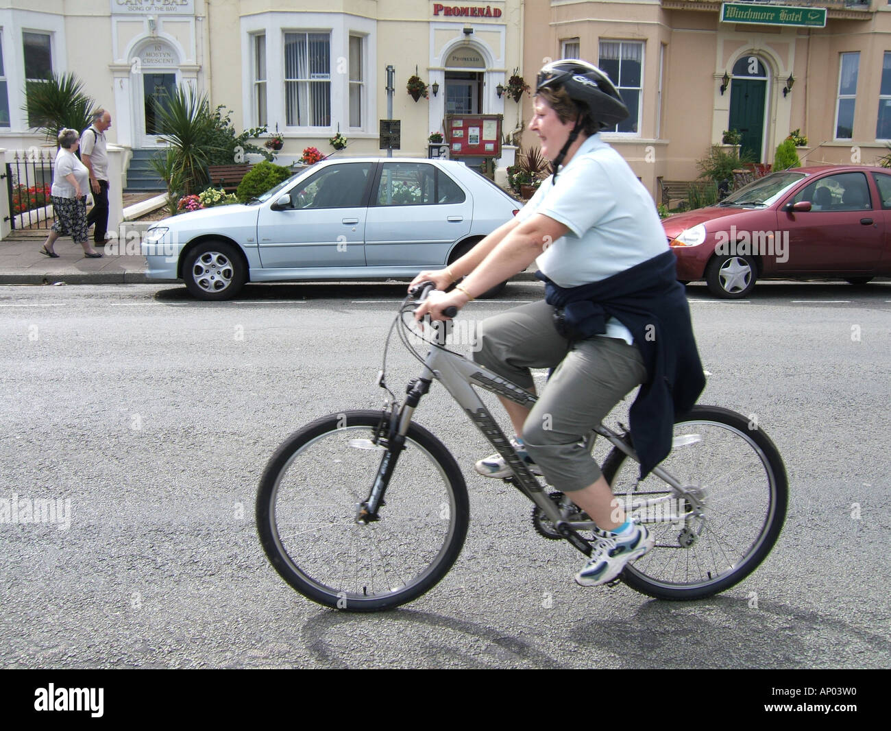 one person riding bike in city street wales Stock Photo - Alamy