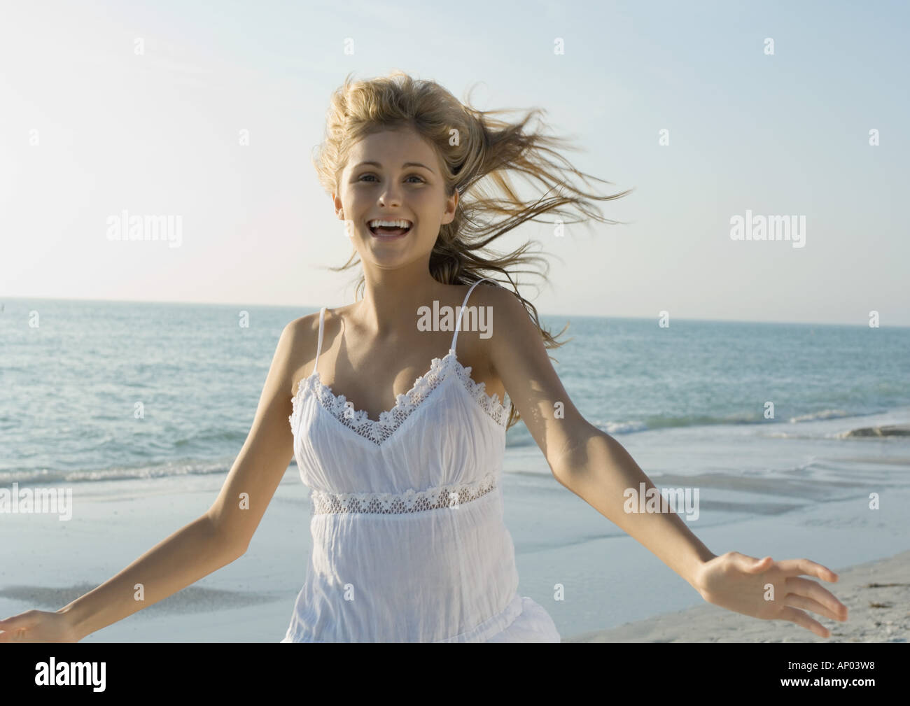 Woman running beach arms out hi-res stock photography and images - Alamy