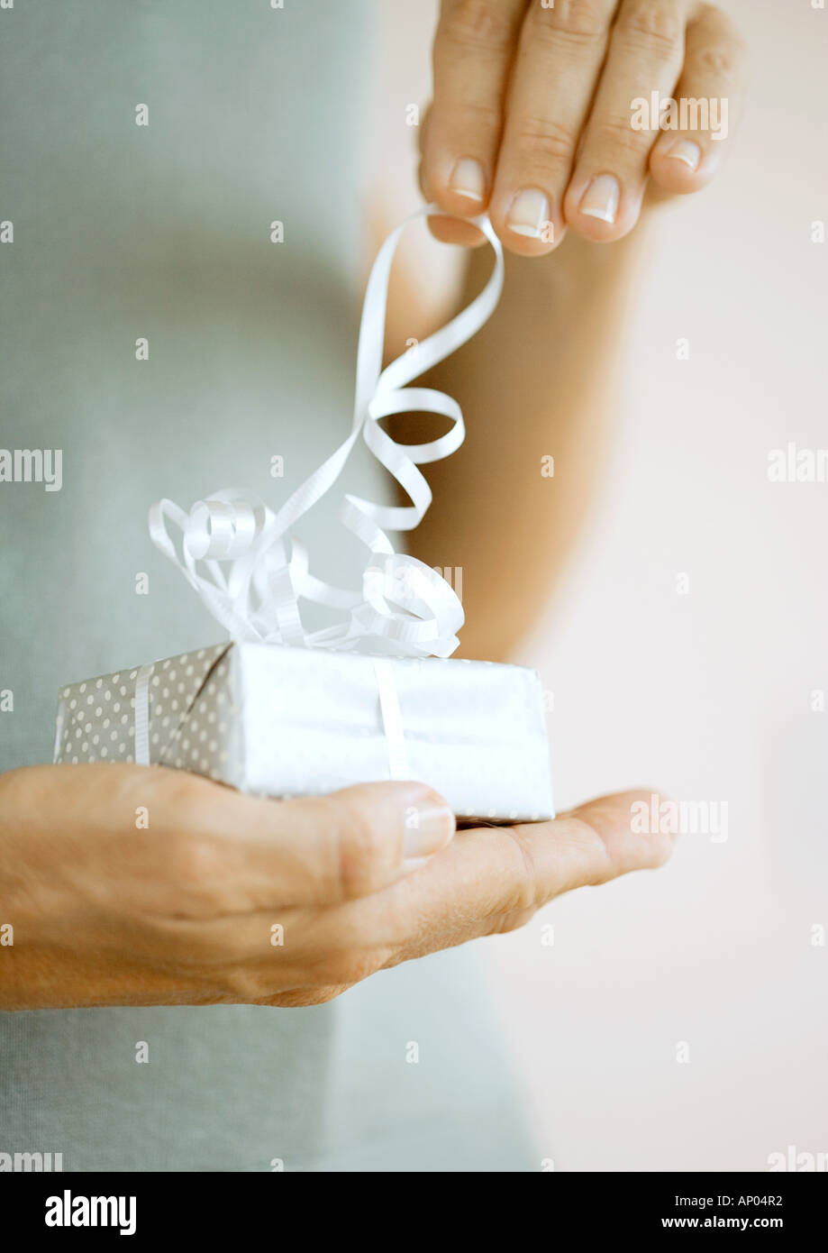 Hands receiving opening gift hi-res stock photography and images - Alamy