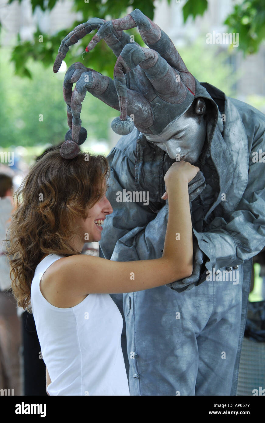 An attractive young woman posing with a street entertainer on London's ...