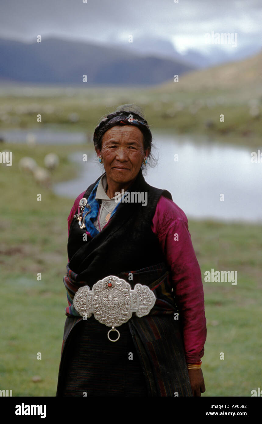 A FEMALE DROKPA Tibetan nomadic yak herder with large SILVER CHUBA ...