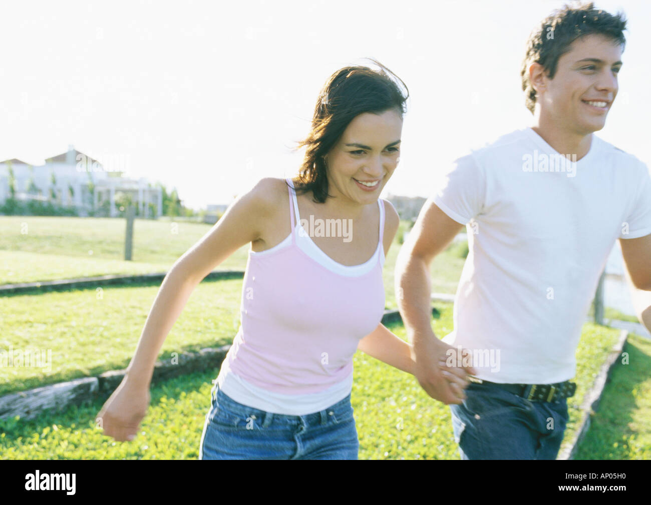Young couple walking, holding hands Stock Photo - Alamy