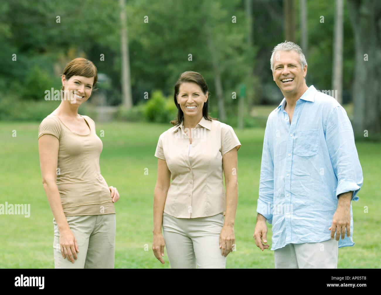 Three mature adults smiling Stock Photo - Alamy