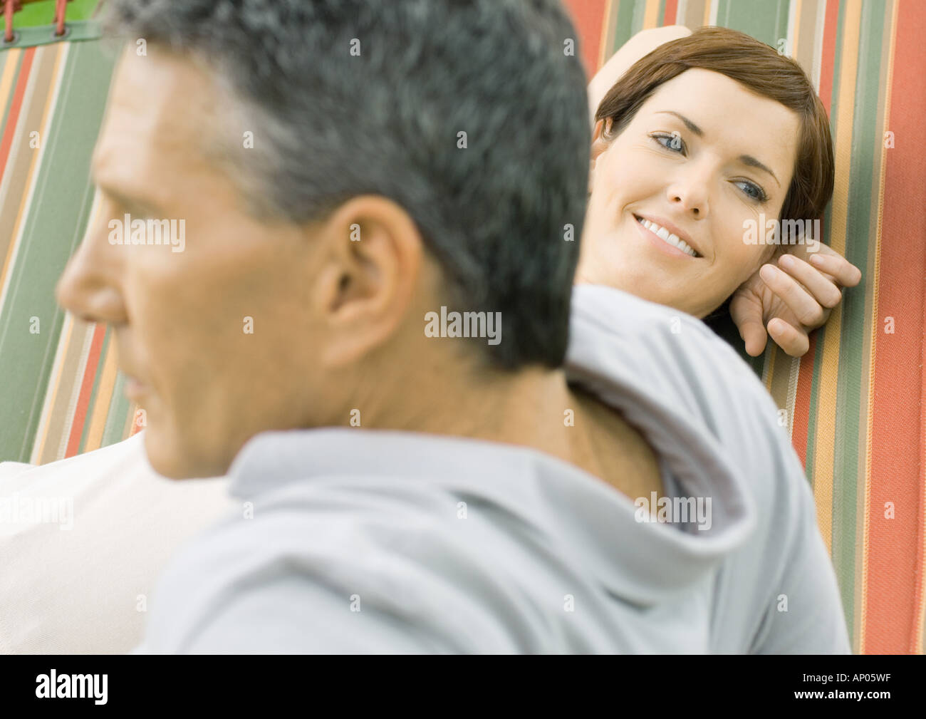 Couple lounging in hammock Stock Photo - Alamy