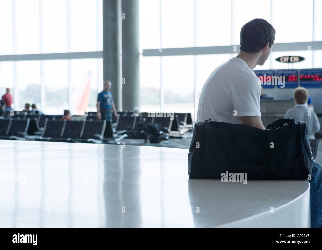 Man waiting near departure gate Stock Photo - Alamy