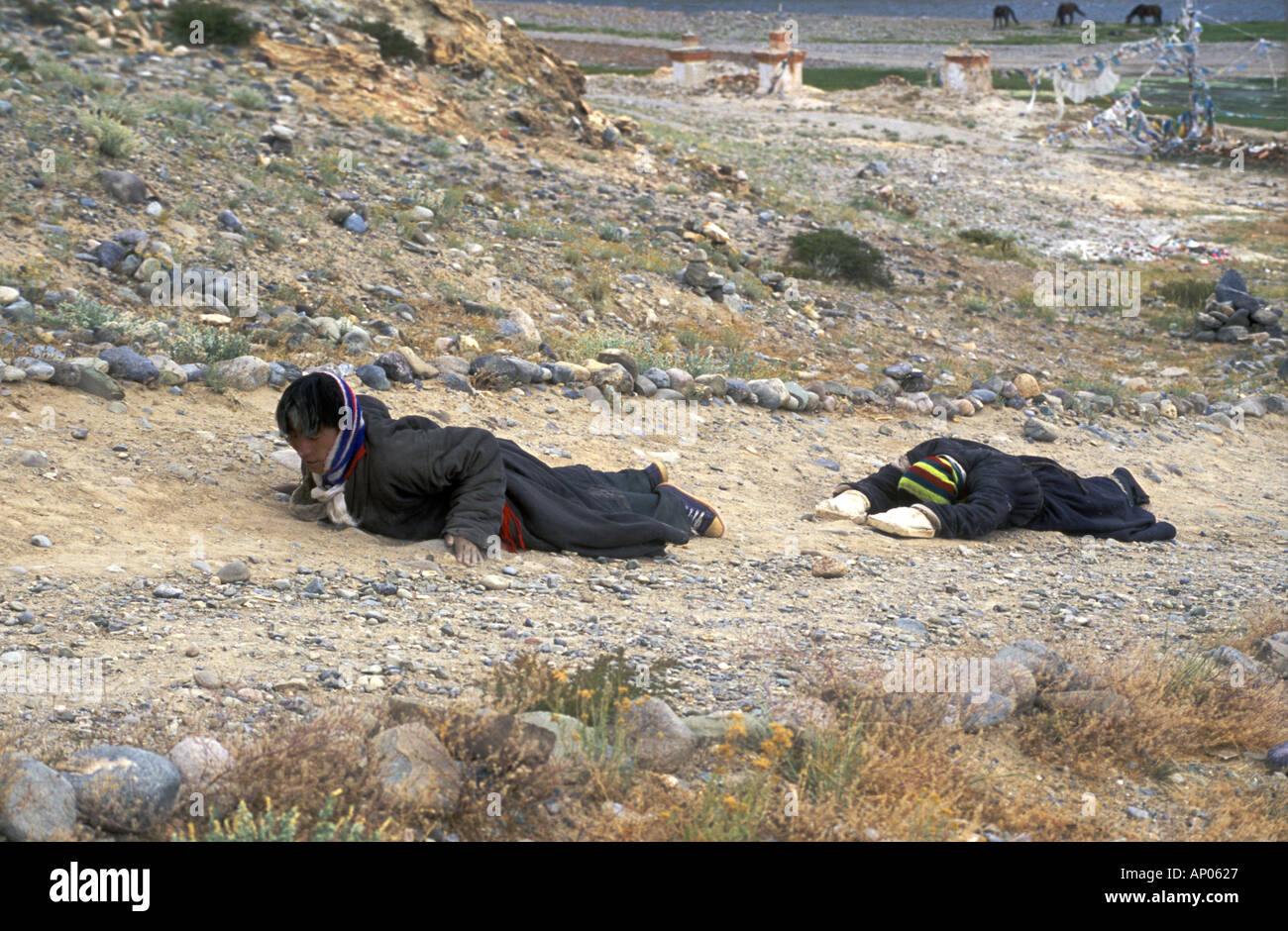 TIBETAN PILGRIMS do PROSTRATIONS at TIRTHAPURI a sacred hot spring ...